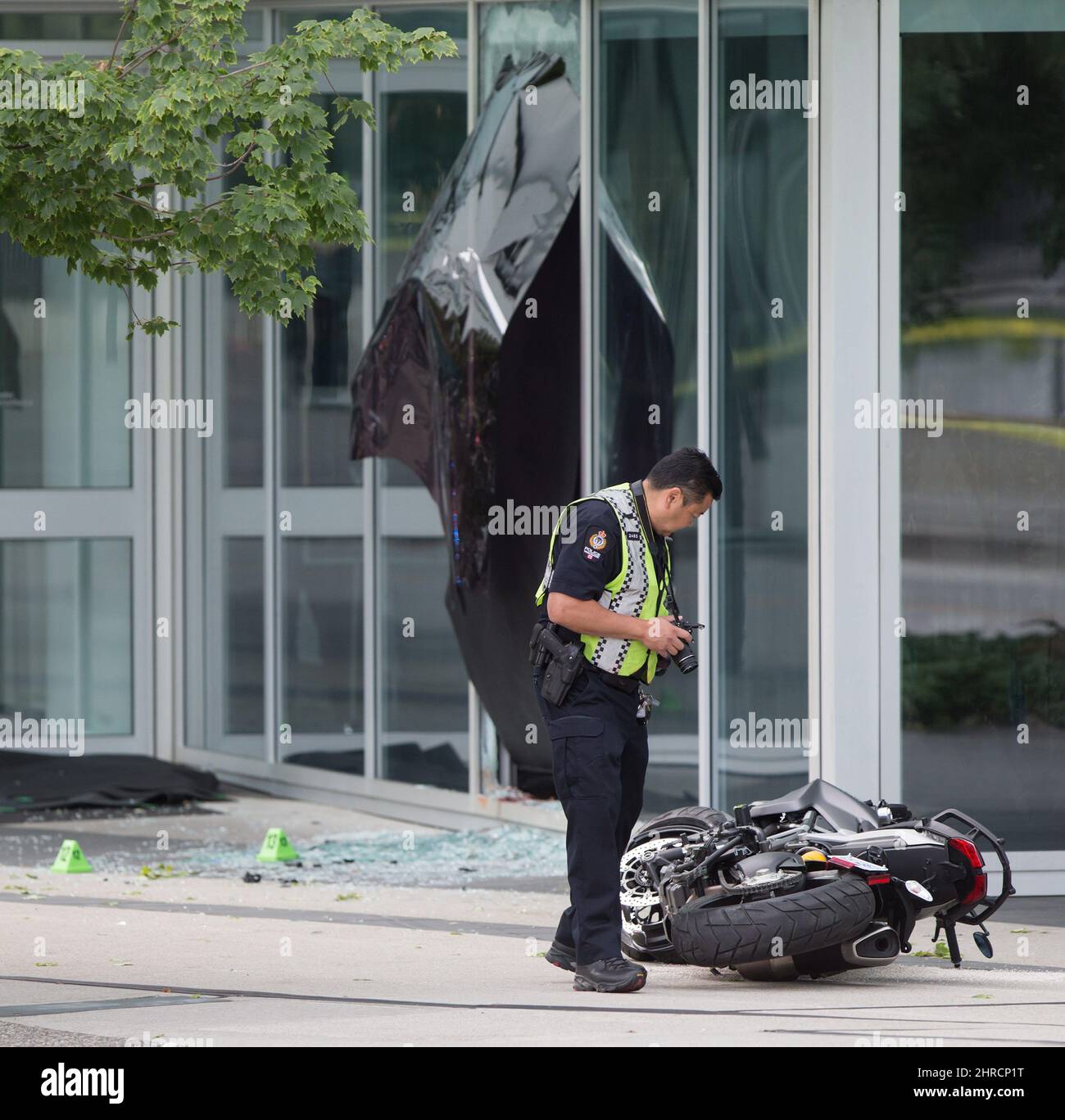 A police officer examines a motorcycle after a female stunt driver ...