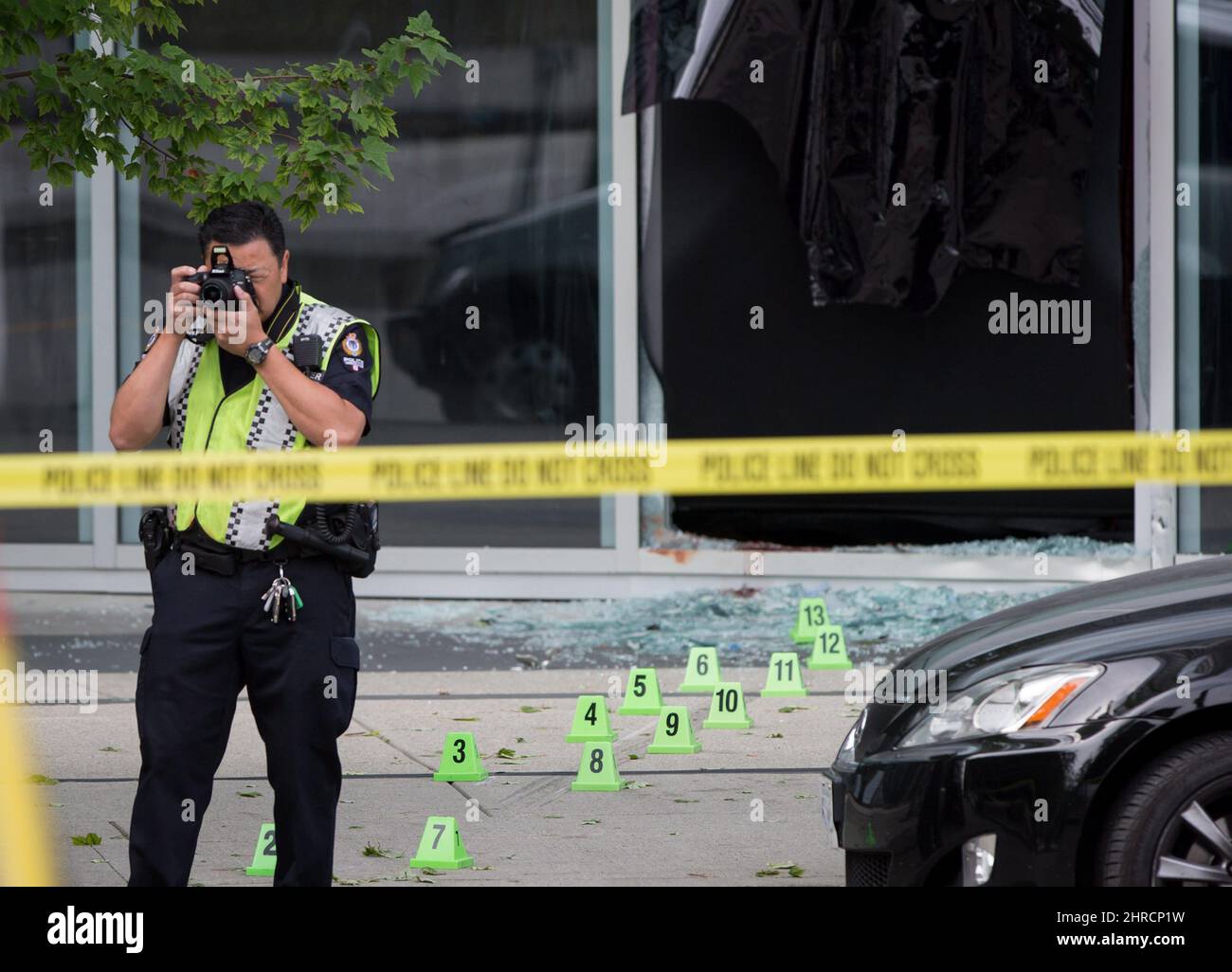 A police officer takes photographs after a female stunt driver working ...