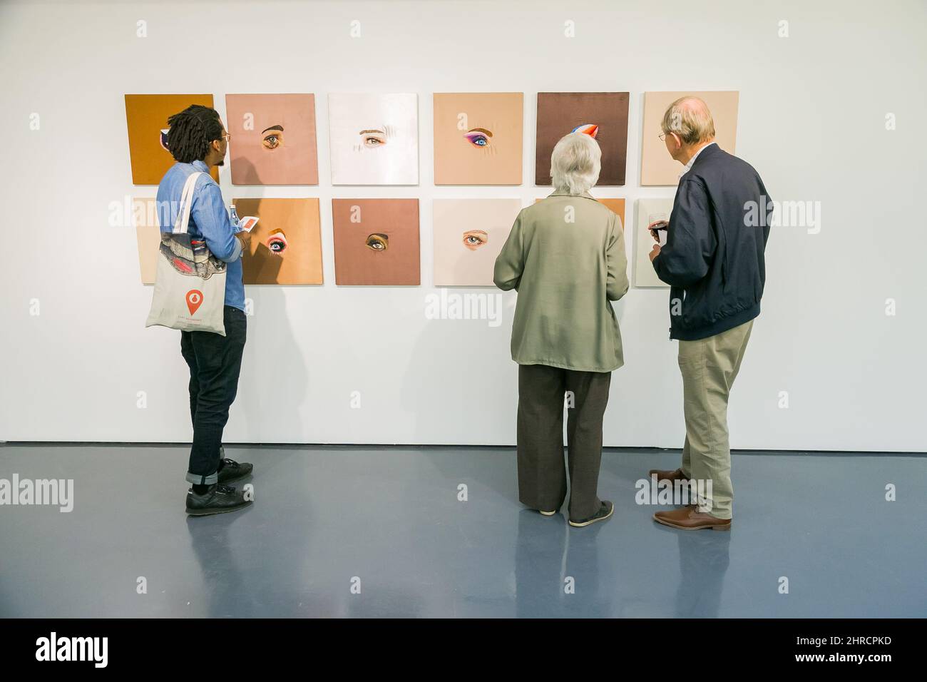 Visitors viewing art exhibit in gallery Stock Photo - Alamy