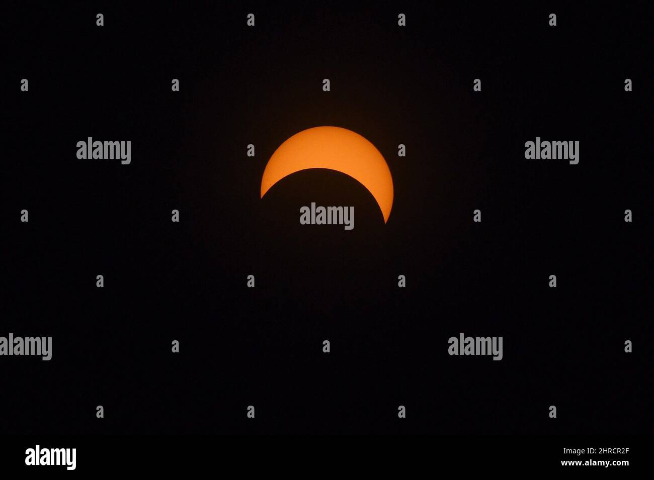 The moon covers the sun during a partial solar eclipse in Ottawa on ...