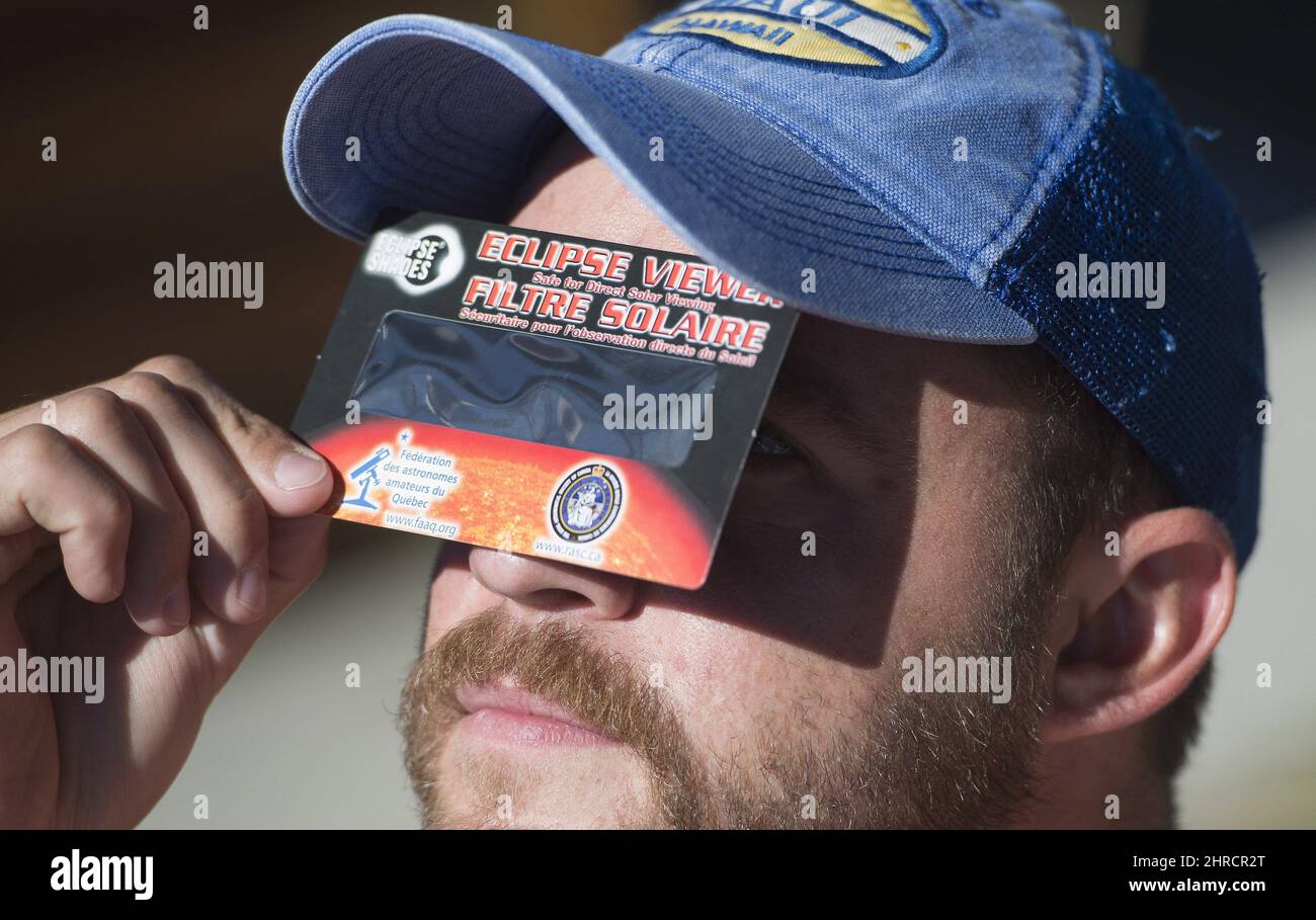 Zack Singer uses a viewer to watch the Solar Eclipse from the top of ...