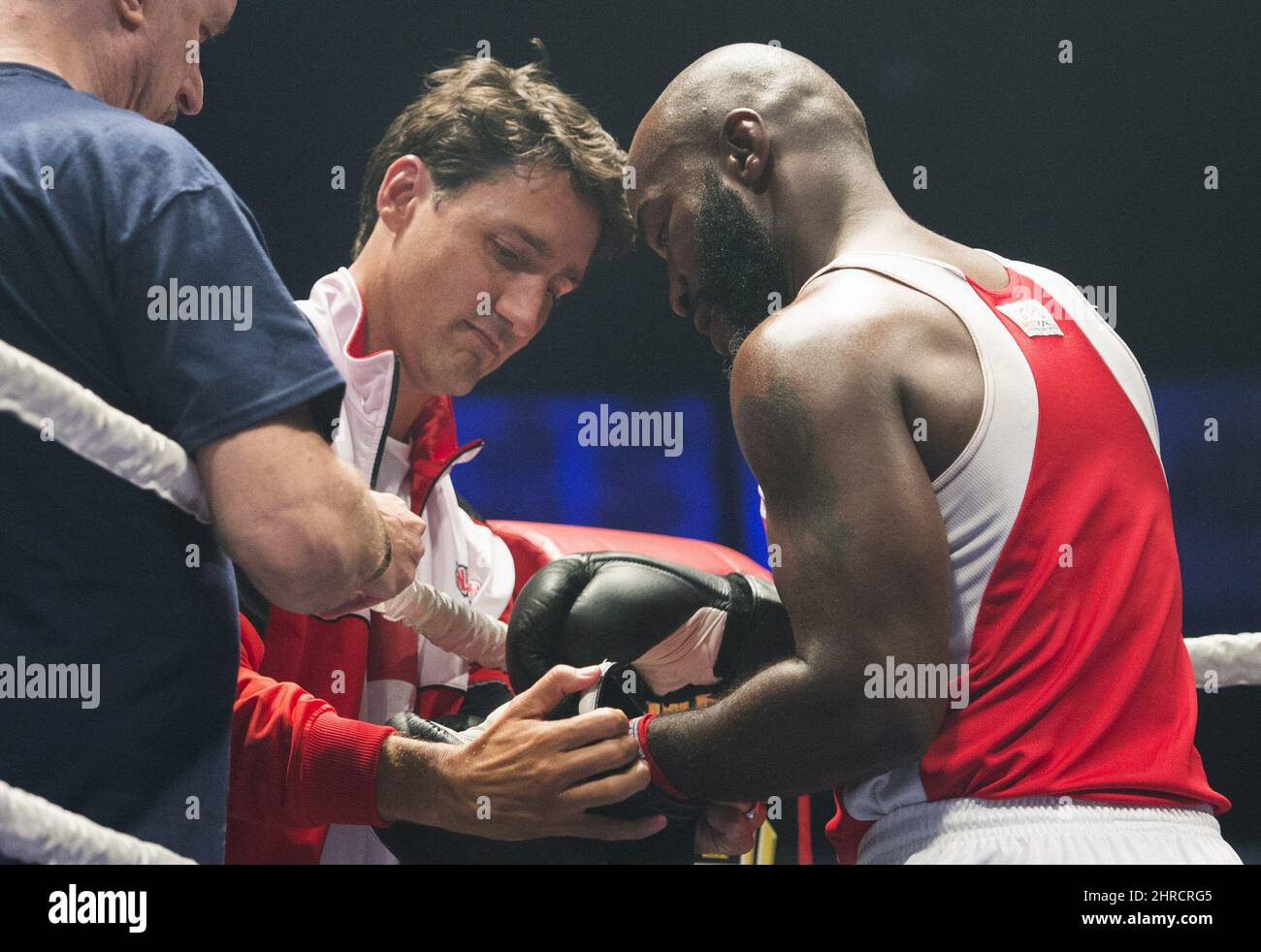 Prime Minister Justin Trudeau, left, helps boxer Ali Nestor with his ...