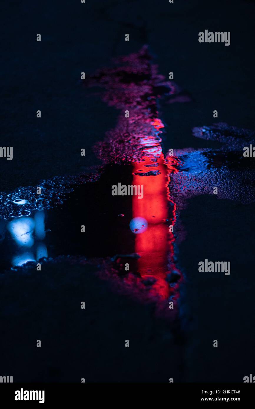 Reflection of neon lights on a water in the ground Stock Photo - Alamy