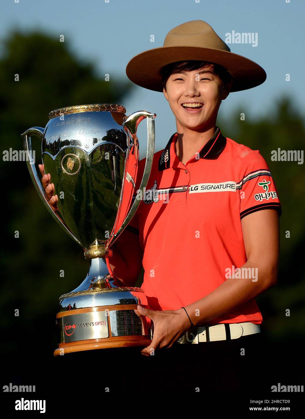 Sung Hyun Park, of South Korea, poses for a photo with the trophy wearing the hat of a Mountie ...