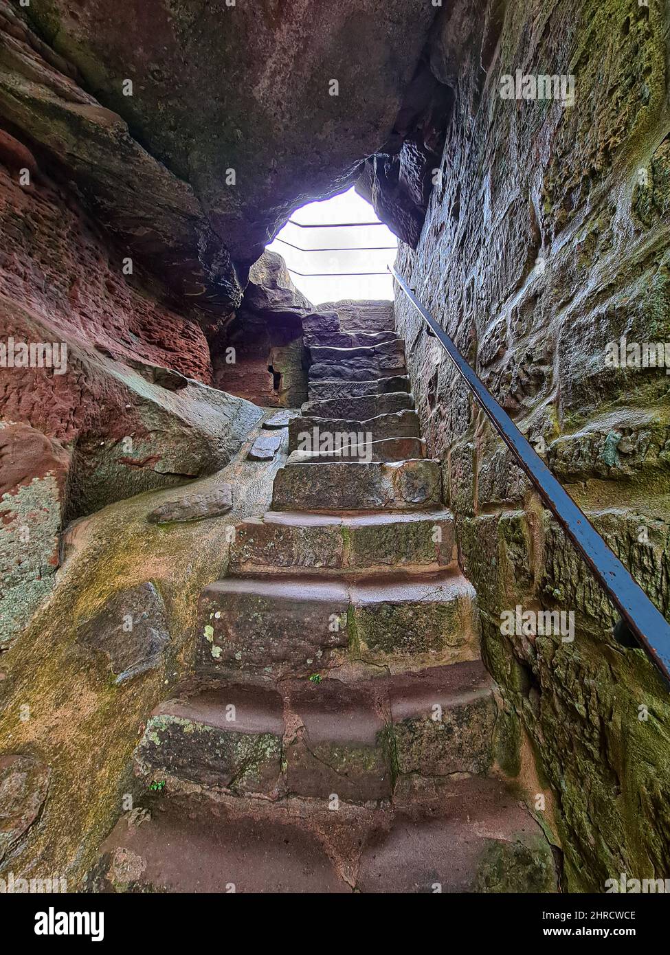 Vertical shot of an old stairs and rocky walls inside ancient building ...