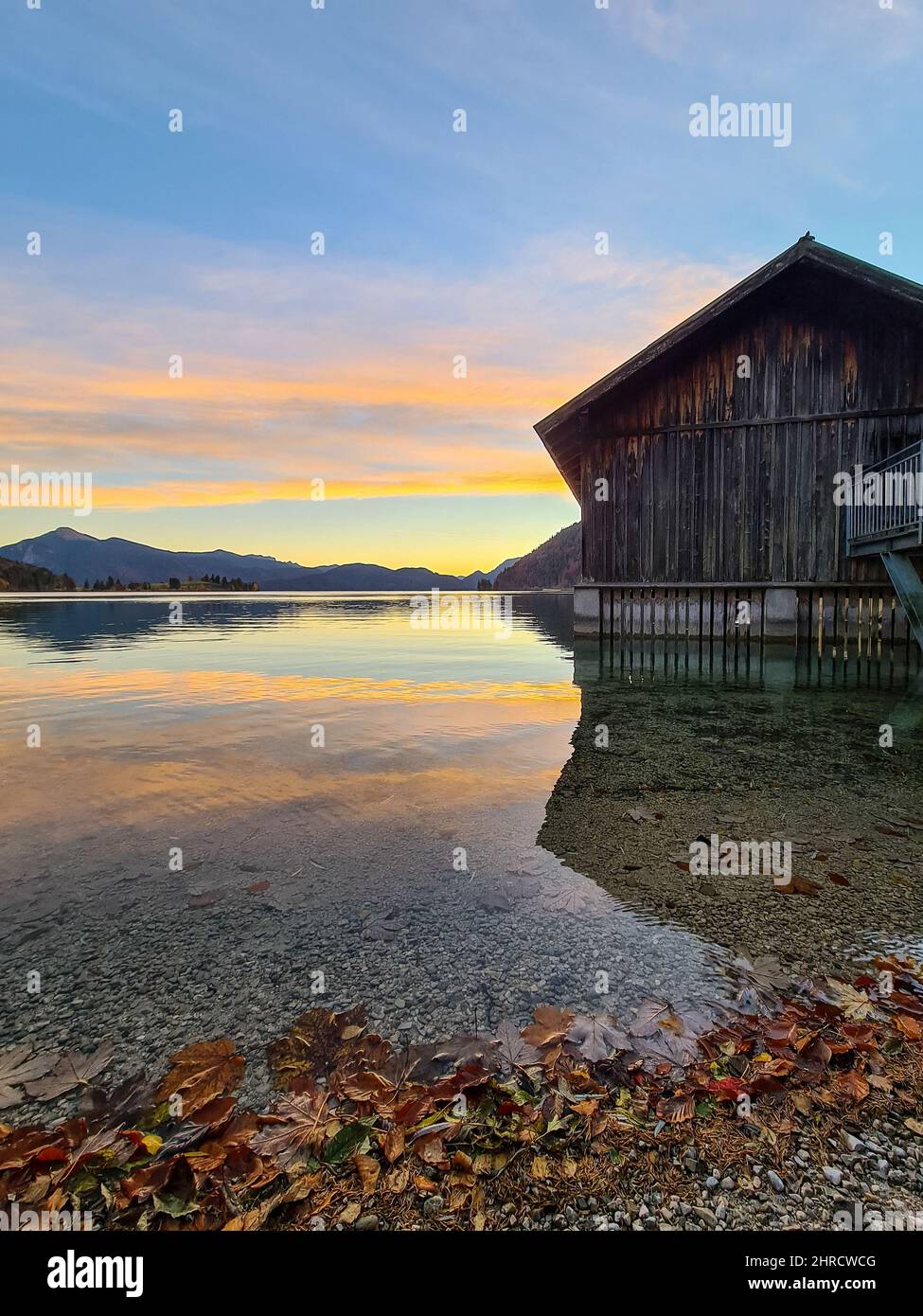 Shot of small Hut with reflection in water and sunset Stock Photo - Alamy