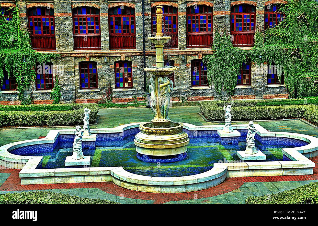 View of a beautiful fountain with statues and trees in a park Stock ...