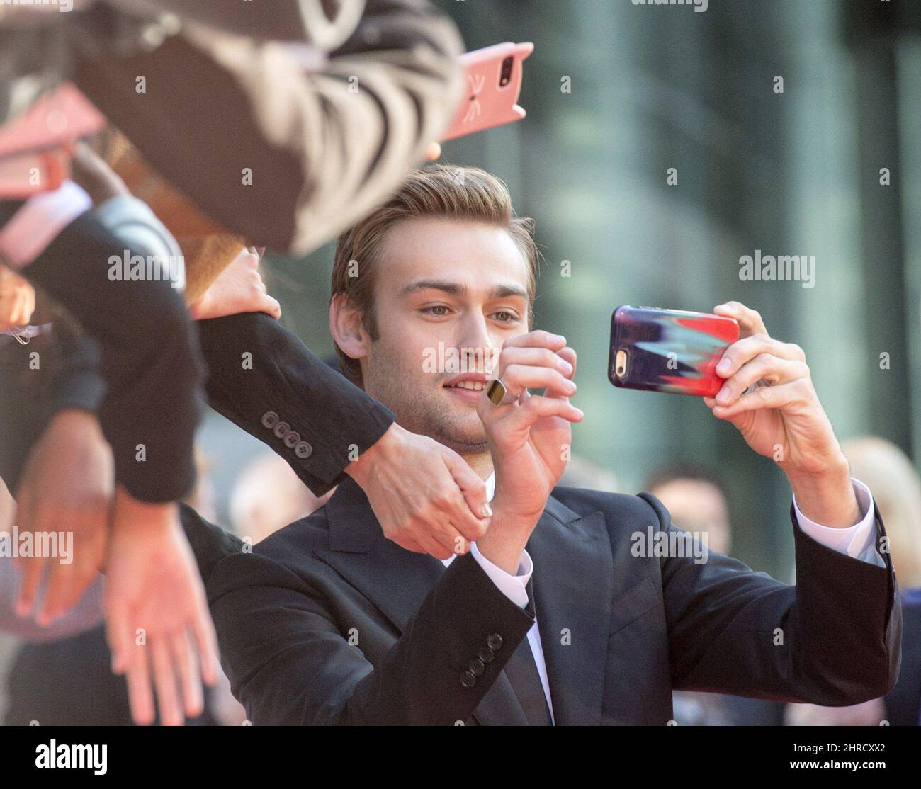 Douglas Booth takes selfies with fans on the red carpet for the ...