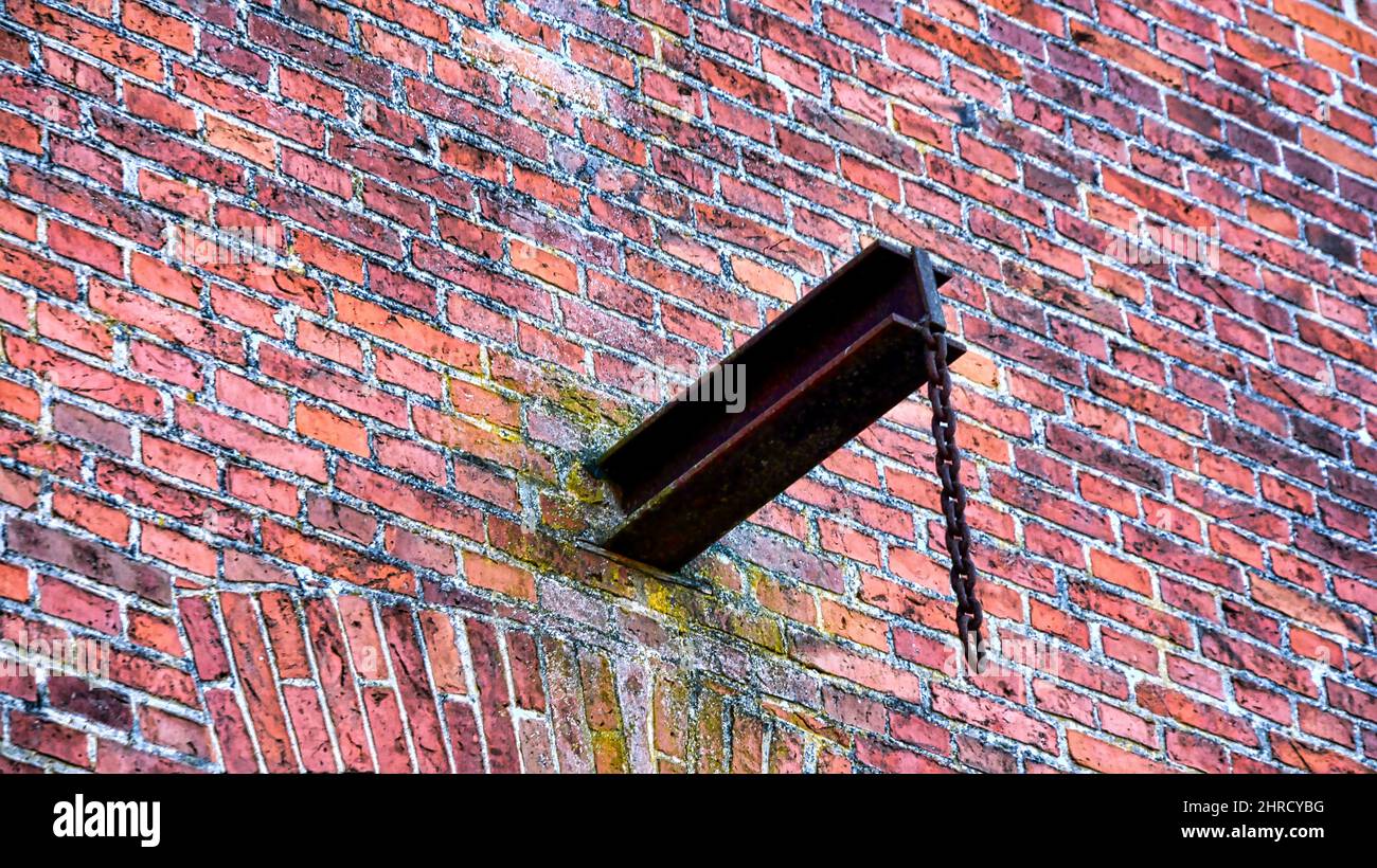 Iron construction in the orange brick wall Stock Photo - Alamy