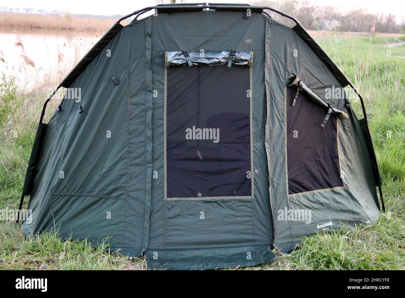 Carp tent on the grassy riverbank Stock Photo - Alamy