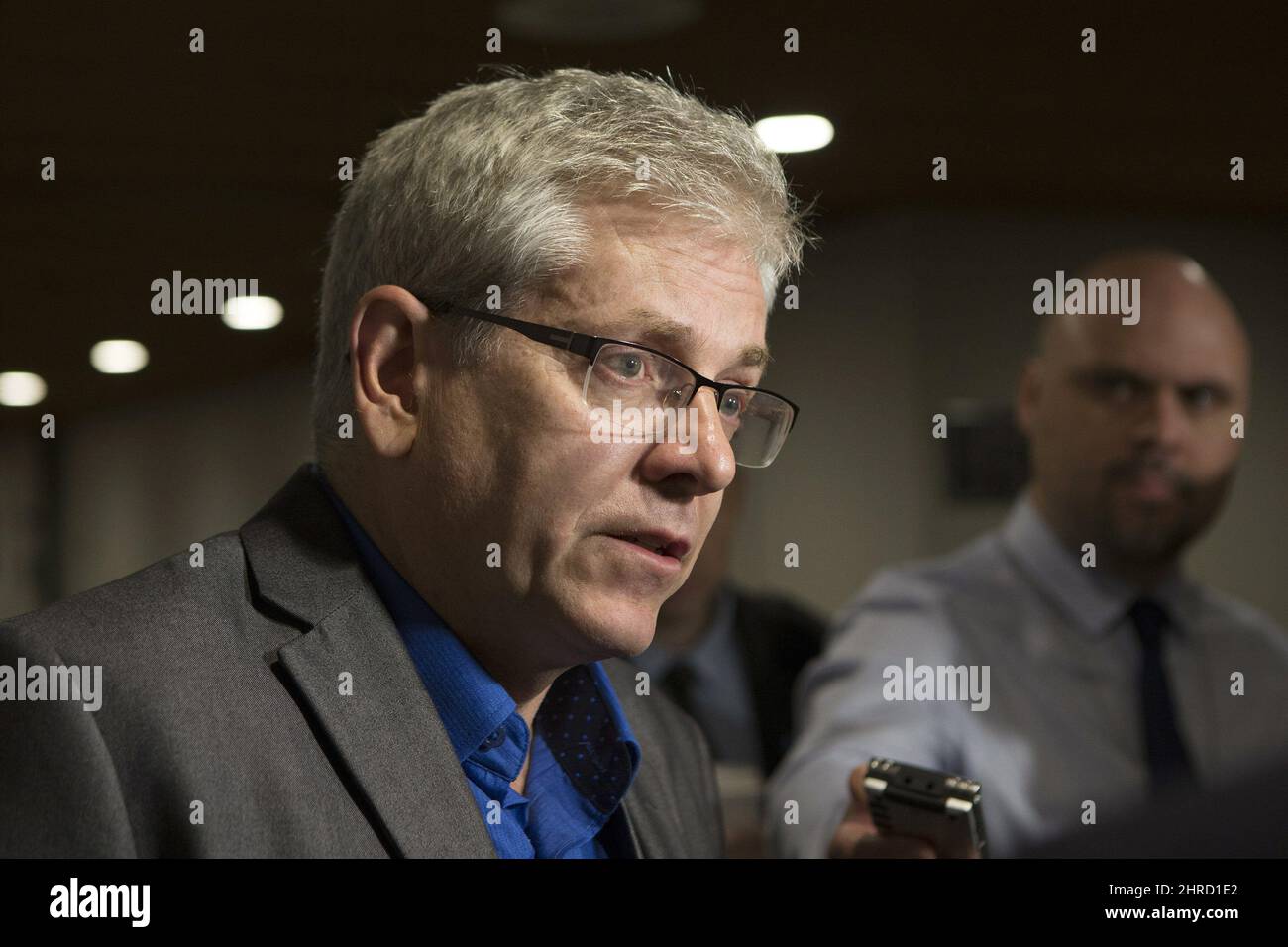 Leadership contender Charlie Angus scrums with journalists as he ...