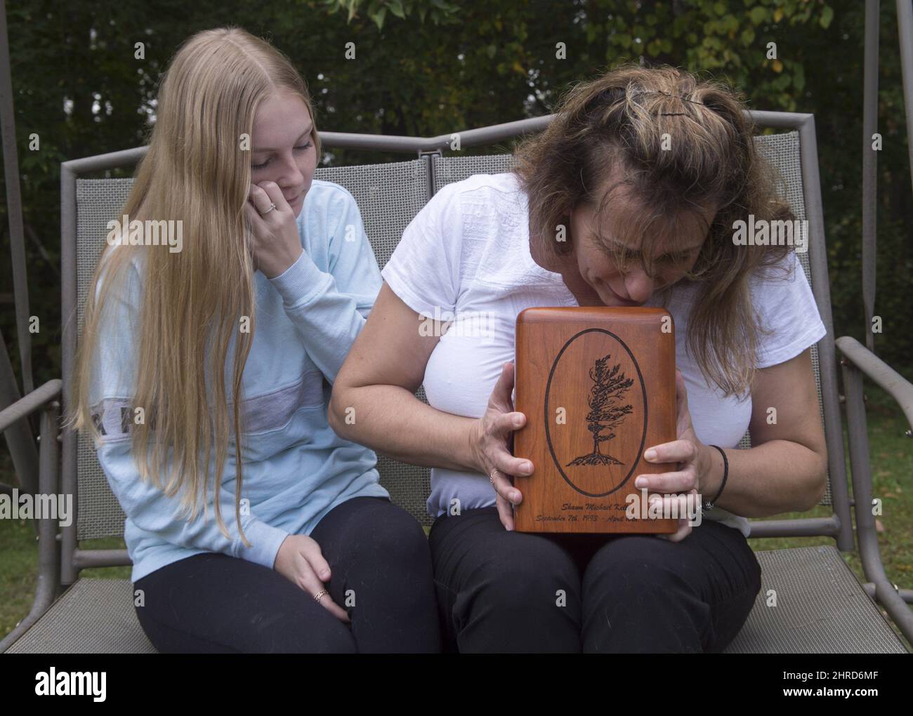 Denise Lane kisses the urn containing the ashes of her son Shawn as her ...