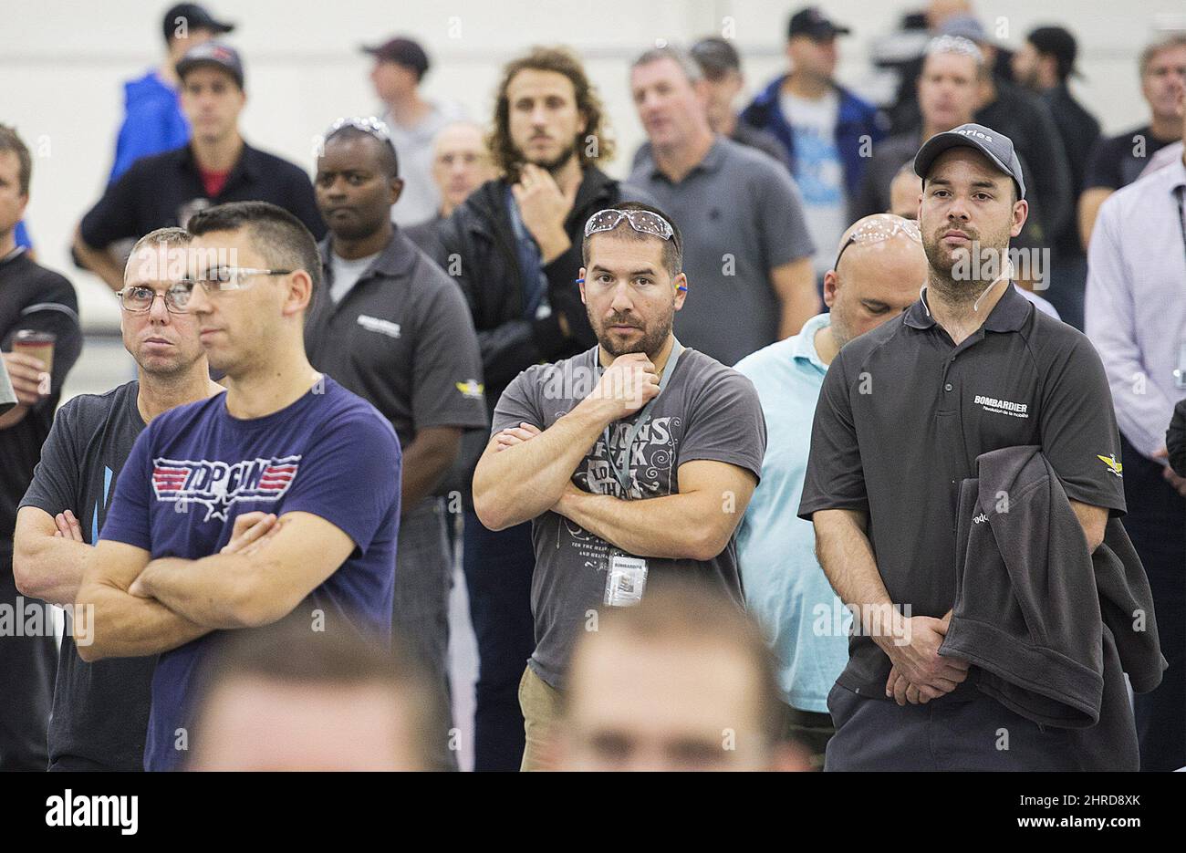 Bombardier employees look on during a visit by Airbus CEO Tom Enders at ...