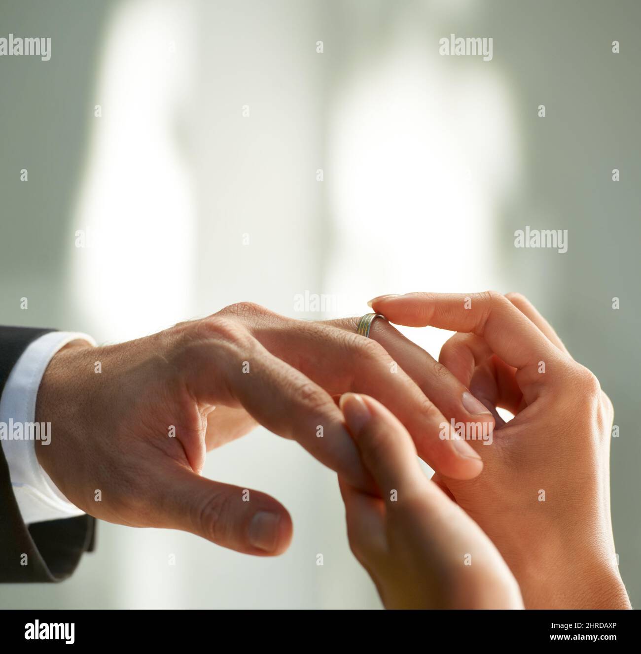 Expressing their love and commitment. Cropped view of a bride slipping ...