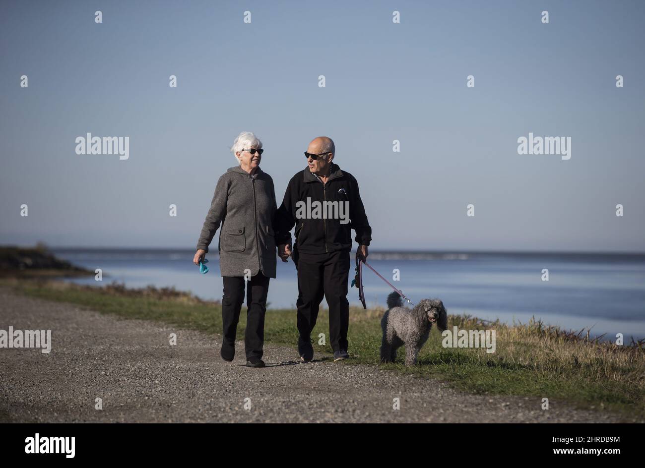 Max Morton and his wife Sharon walk their dog Barney along the Fraser ...