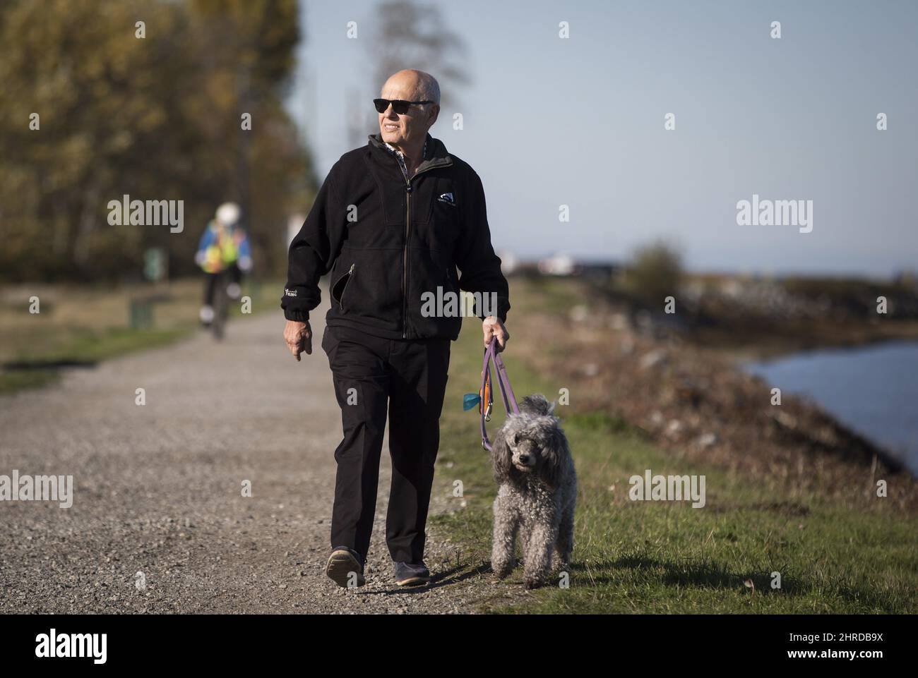 Max Morton, 81, walks his dog Barney along the Fraser River near his ...