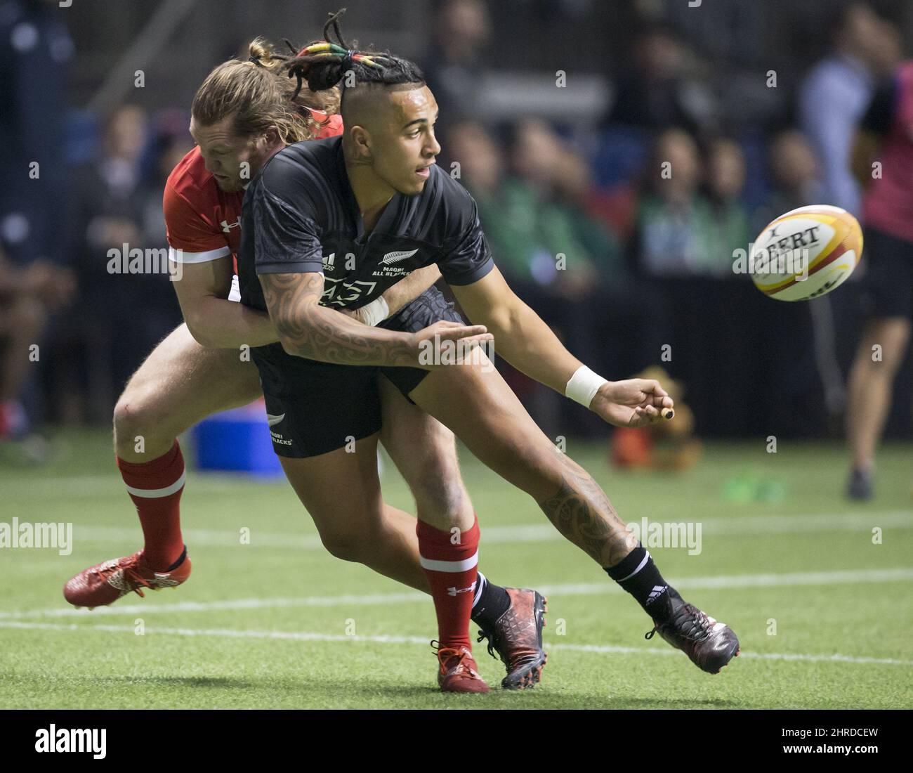 Maori All Blacks' Sean Wainui, front, passes the ball as Canada's Dan ...
