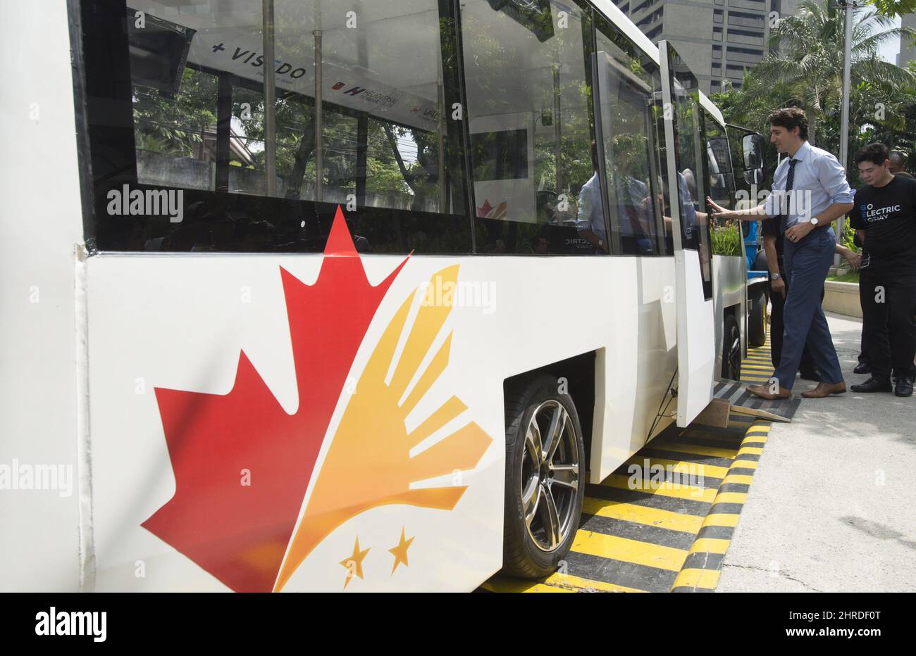Canadian Prime Minister Justin Trudeau steps onto an e-Jeepney during ...