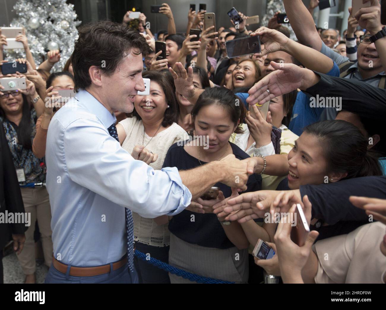 Canadian Prime Minister Justin Trudeau shakes hands as he walks through ...
