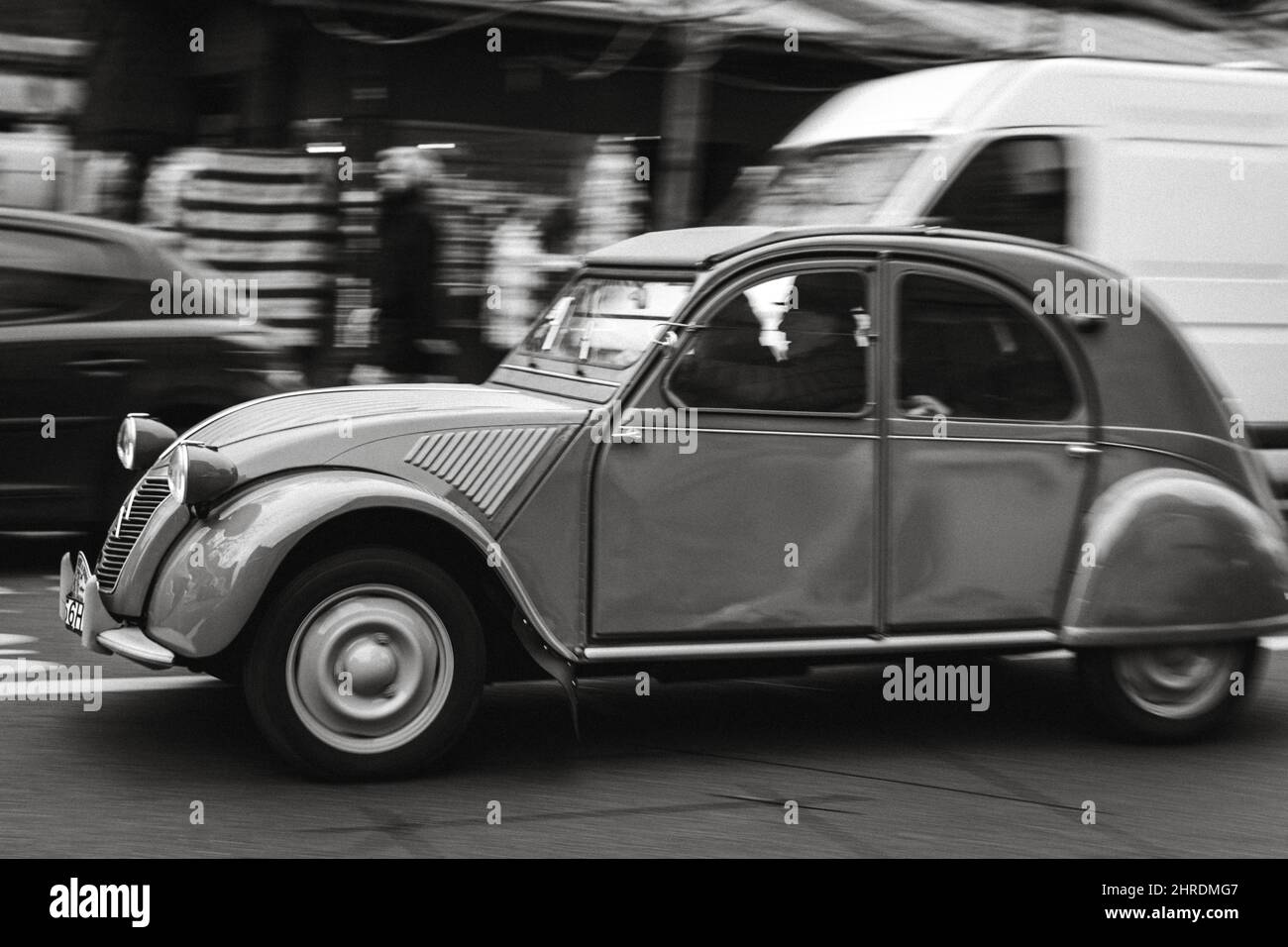 Grayscale of a classic Citroen 2CV car driving on the street Stock ...
