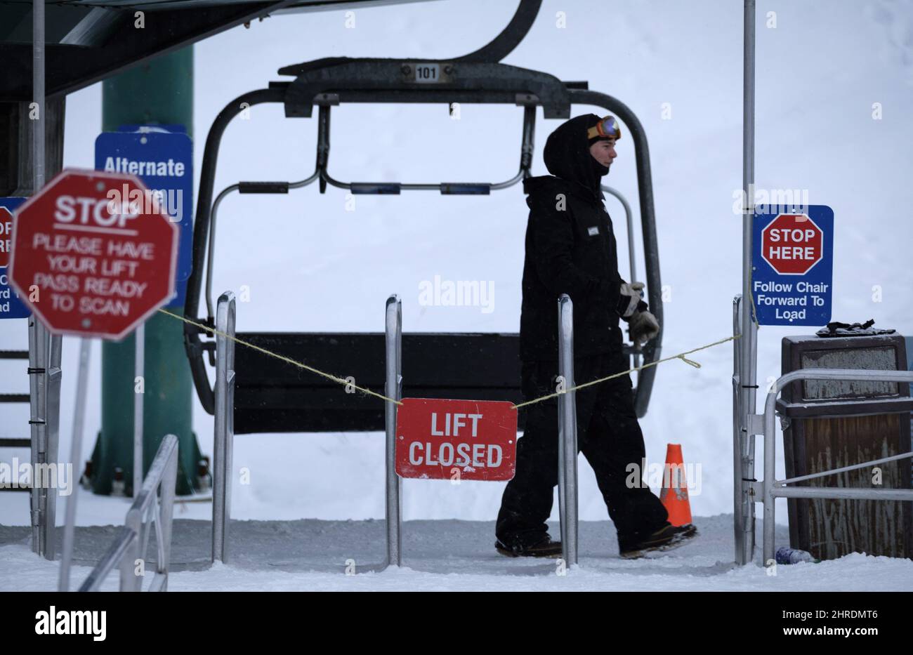 A chair lift worker walks past a closed lift after a power failure shut ...