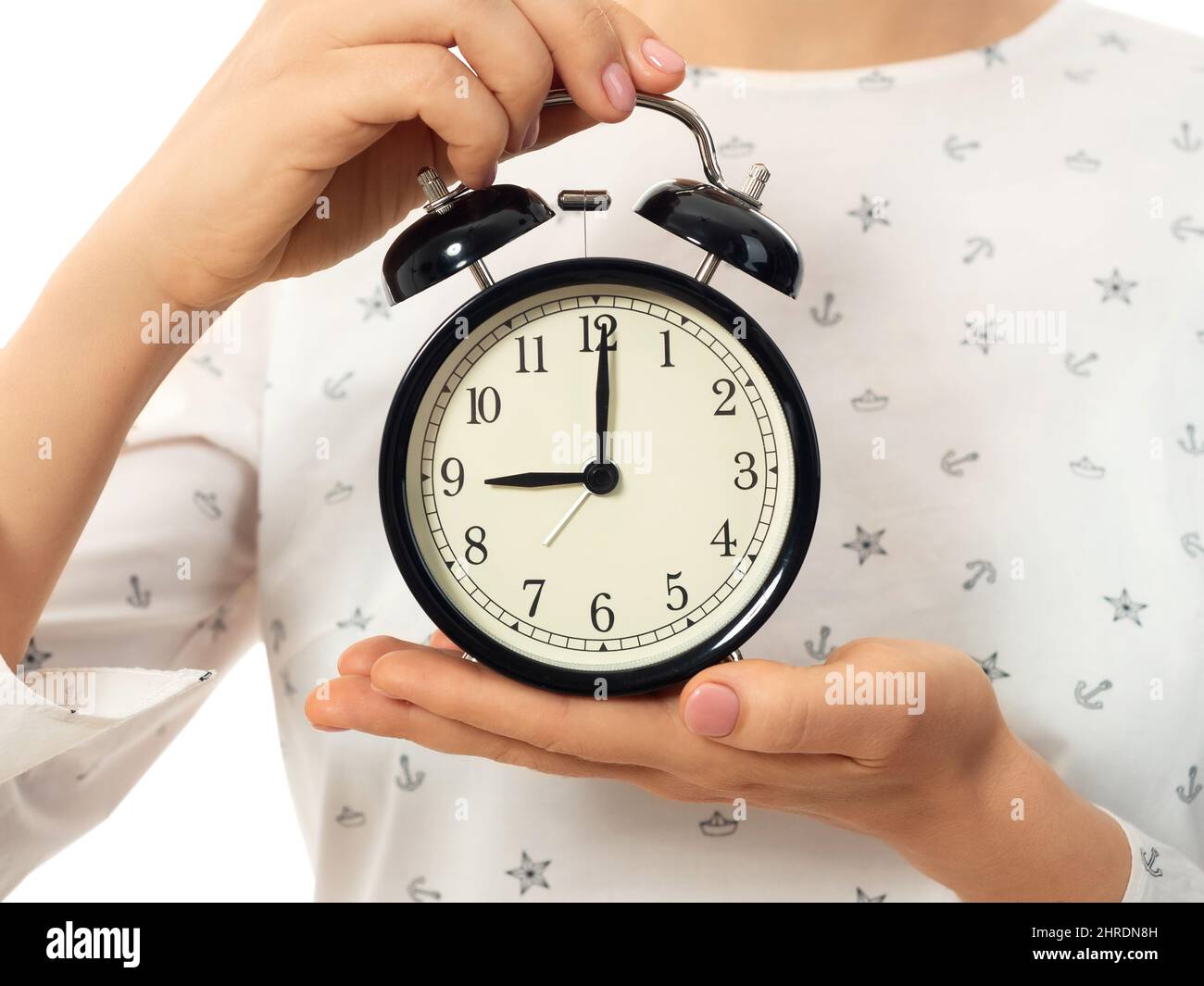 Woman hands holding black alarm clock Stock Photo - Alamy