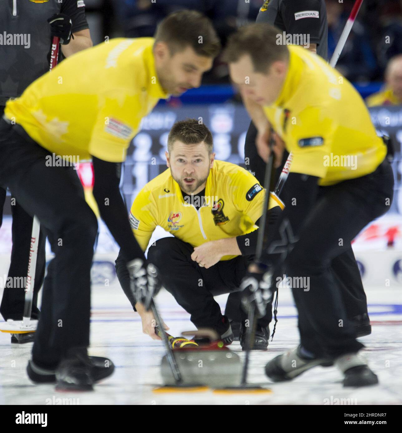 Skip Mike McEwen, from Winnipeg watches his rock as second Matt Wozniak ...