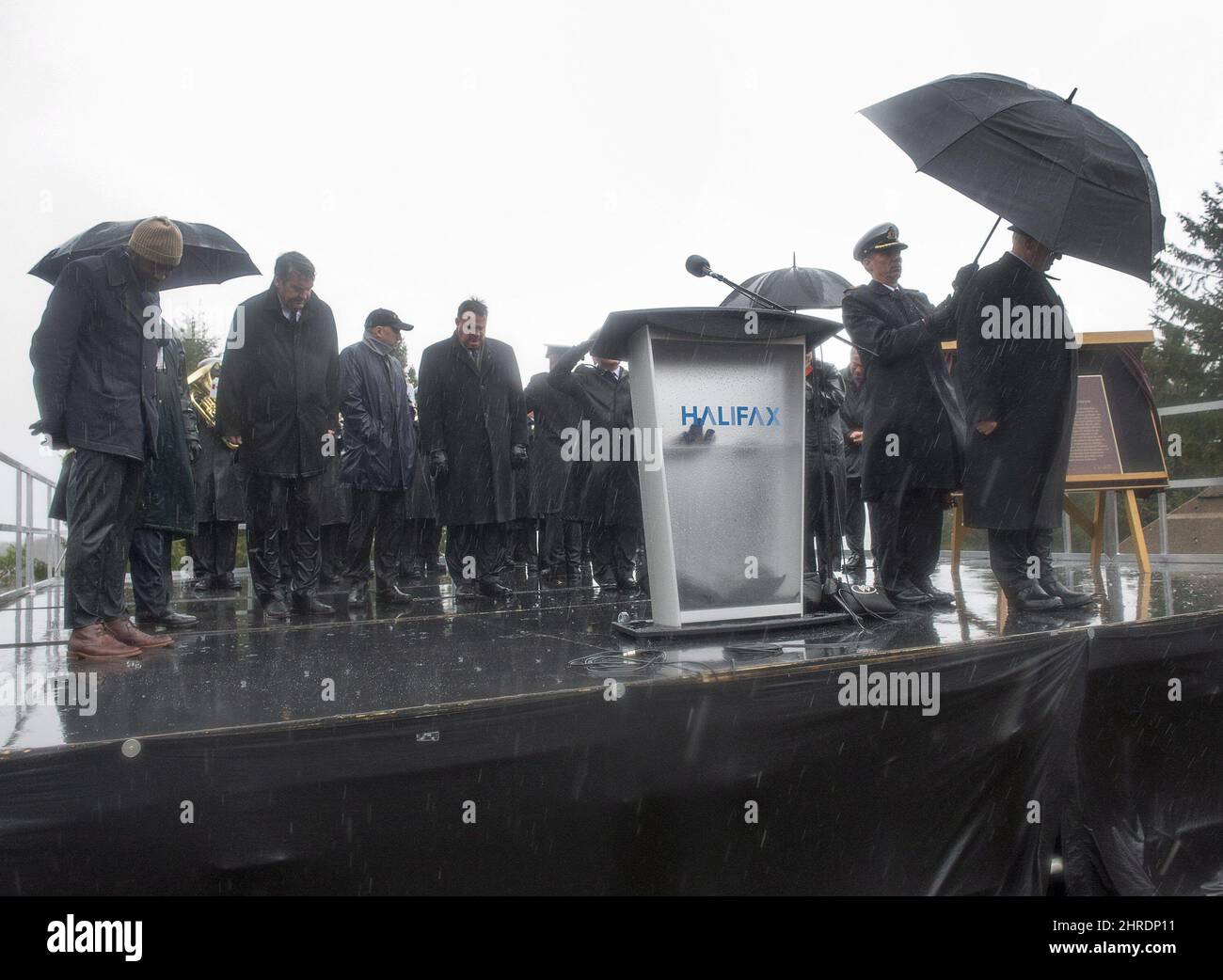 Dignitaries battle the elements at a ceremony to mark the 100th ...