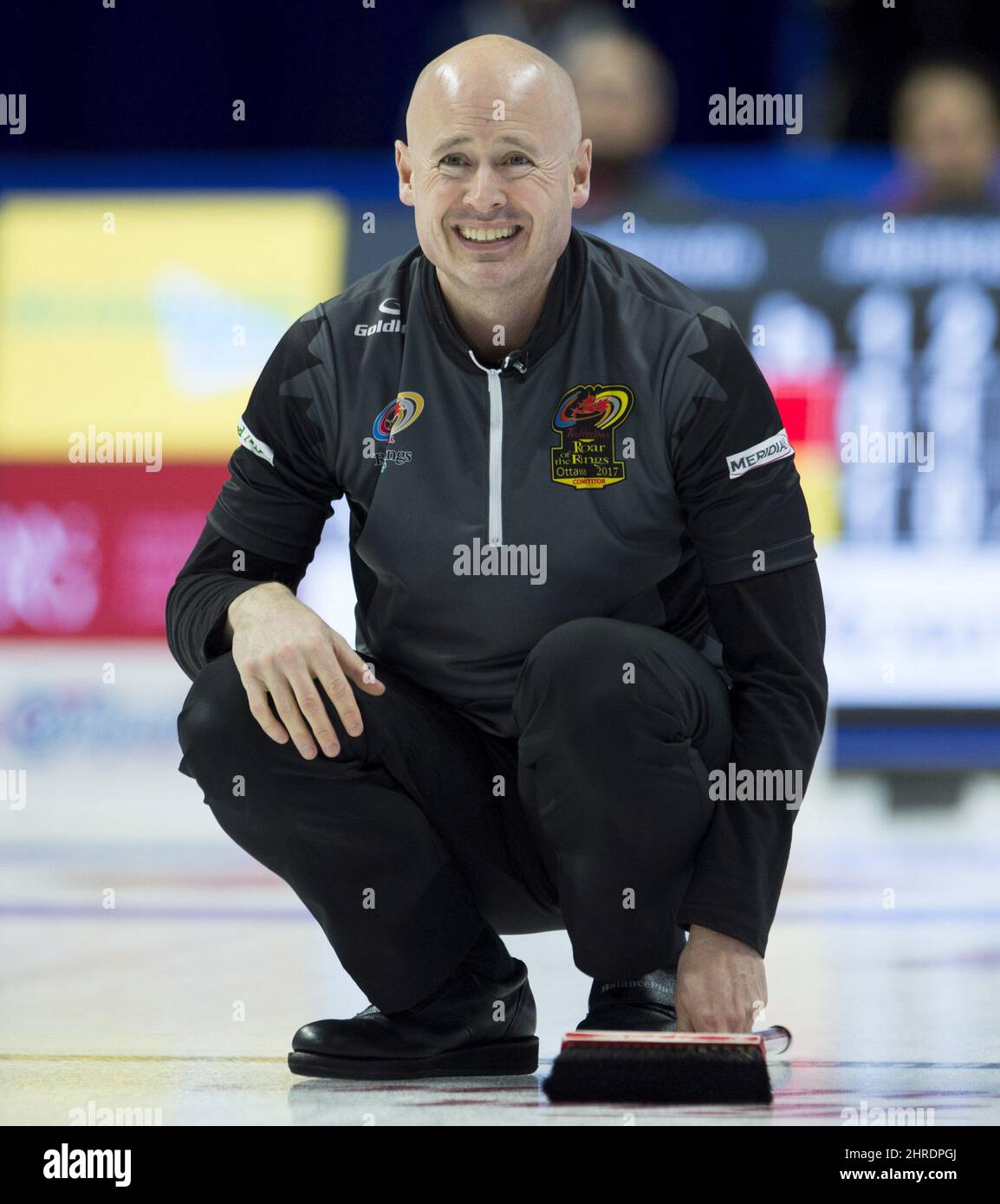 Skip Kevin Koe, from Calgary, Alta smiles as his stone enters the house ...