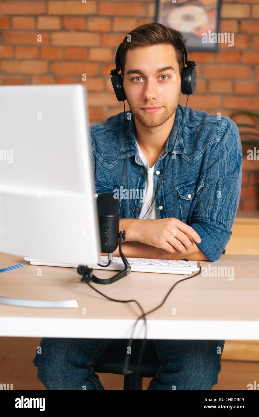 Vertical portrait of handsome audio blogger streamer male wearing ...