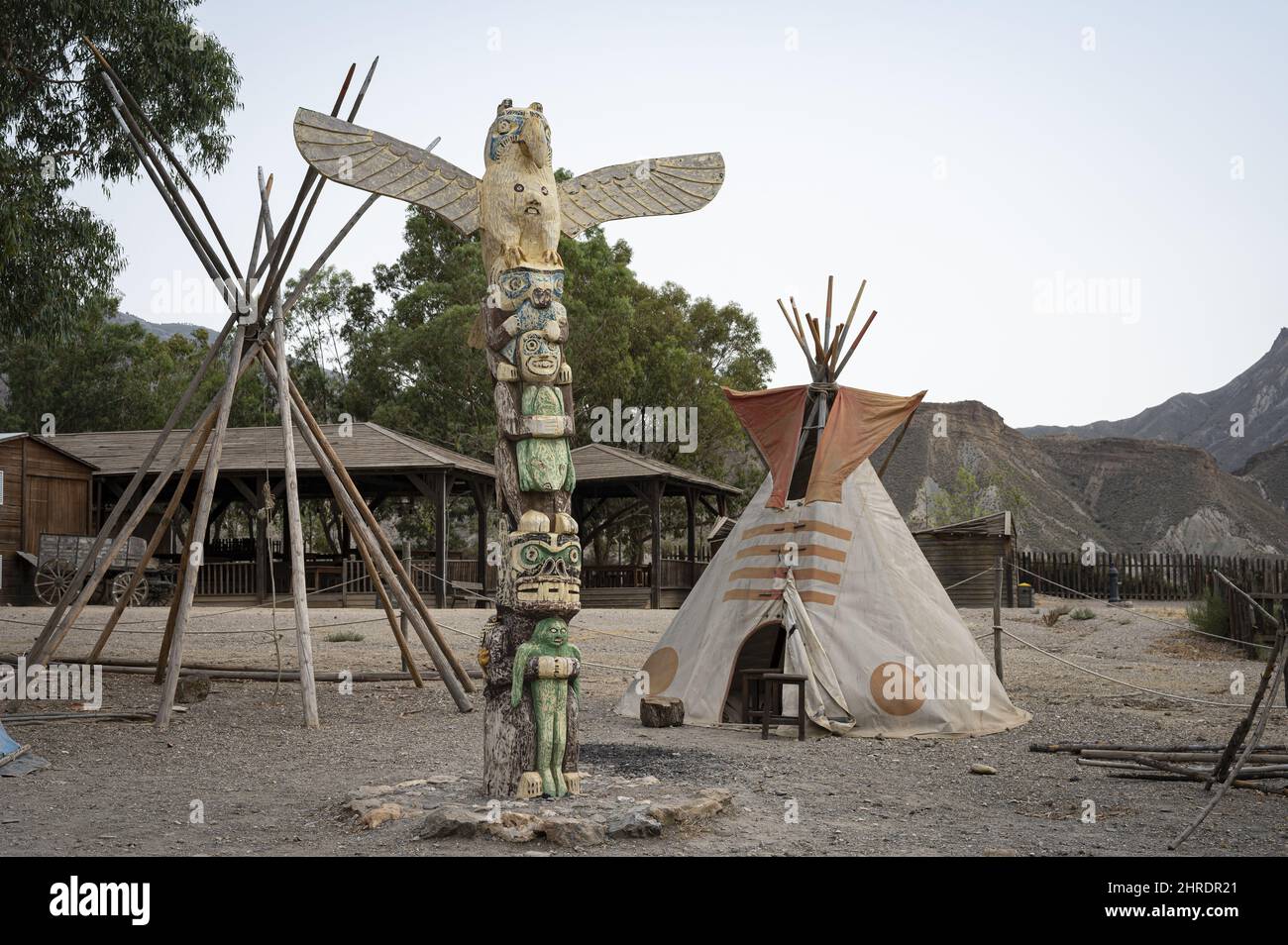 Beautiful shot of Tipi Teepee Indian huts and a totem pole in the ...