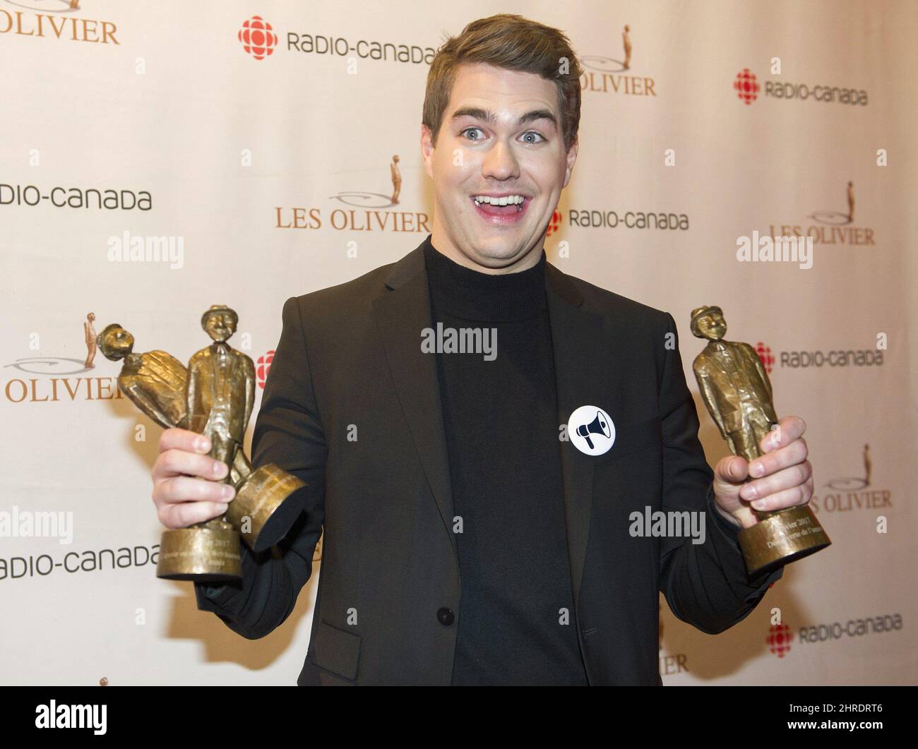 Julien Lacroix holds up his three trophies at the gala Olivier awards ...