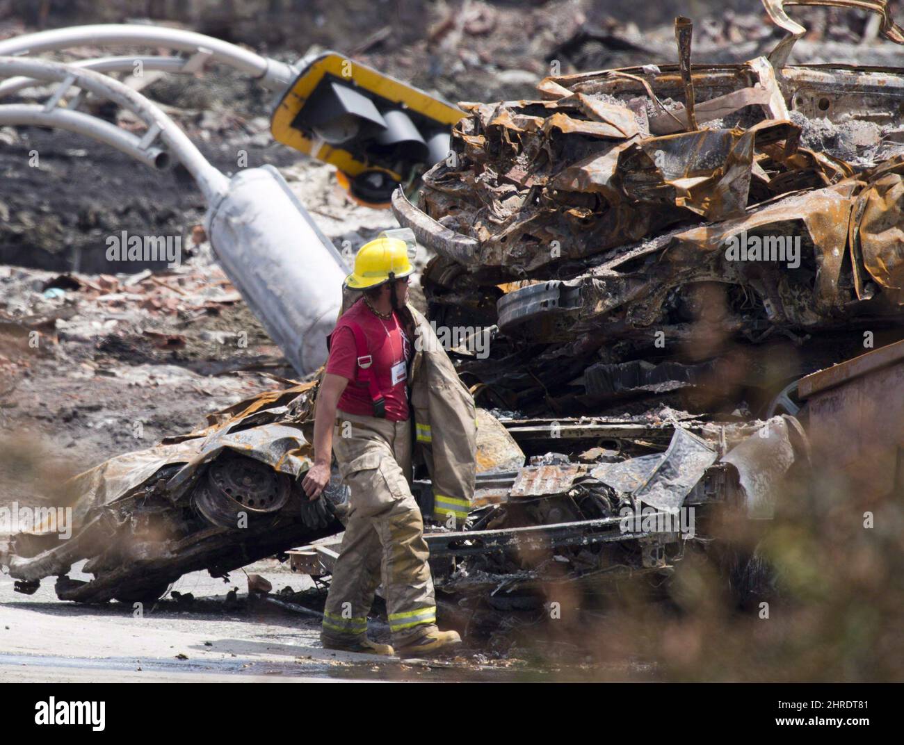 A firefighter walks by rubble on the train crash site in Lac-Megantic ...