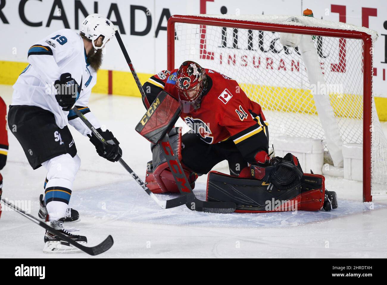 San Jose Sharks' Joe Thornton, left, has his shot blocked by Calgary ...