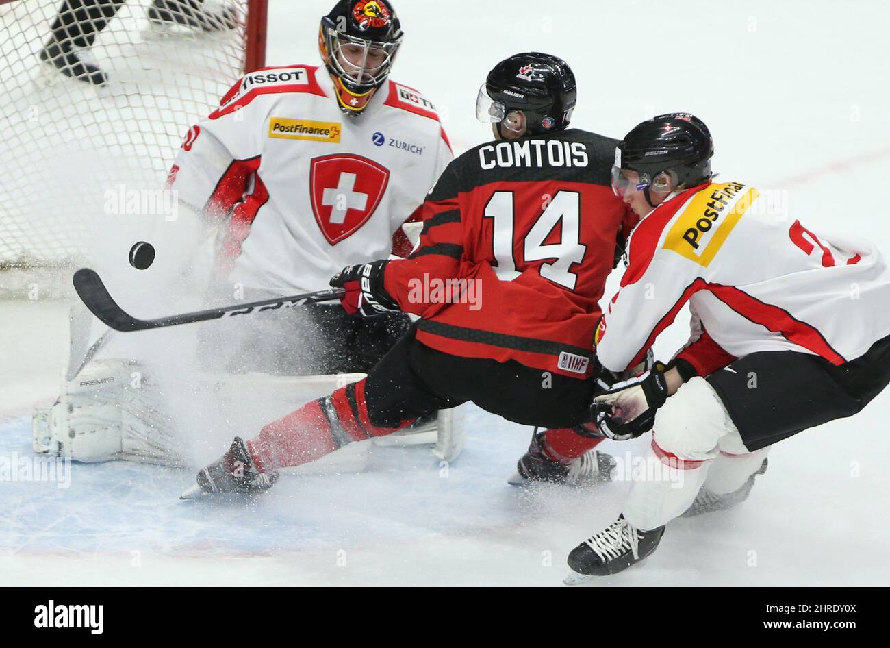 Canada's Maxime Comtois (14) gets in tight against Switzerland goalie ...