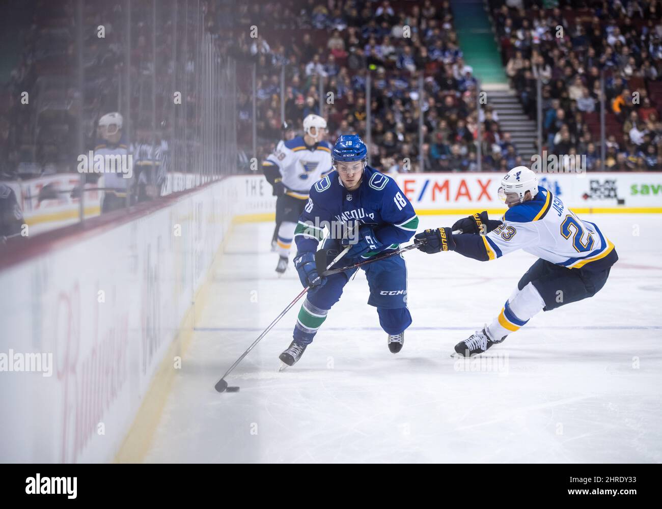 Vancouver Canucks' Jake Virtanen, left, is checked by St. Louis Blues ...