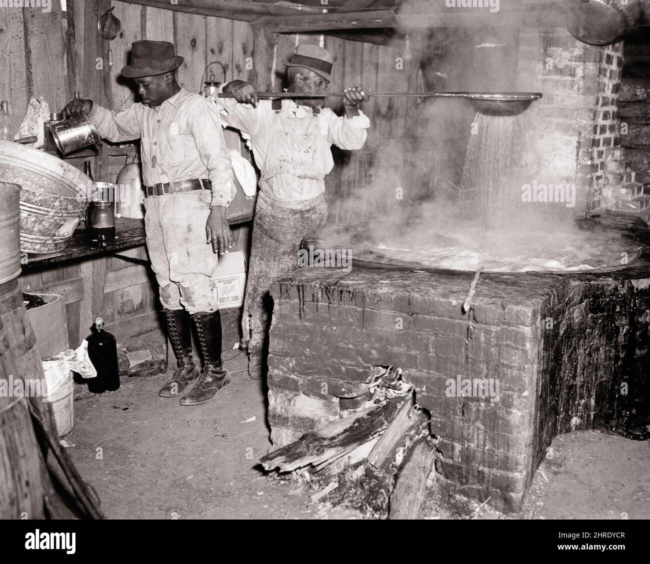 1930s TWO AFRICAN AMERICAN WORKERS MAKING HOMEMADE MOLASSES FROM SUGAR ...