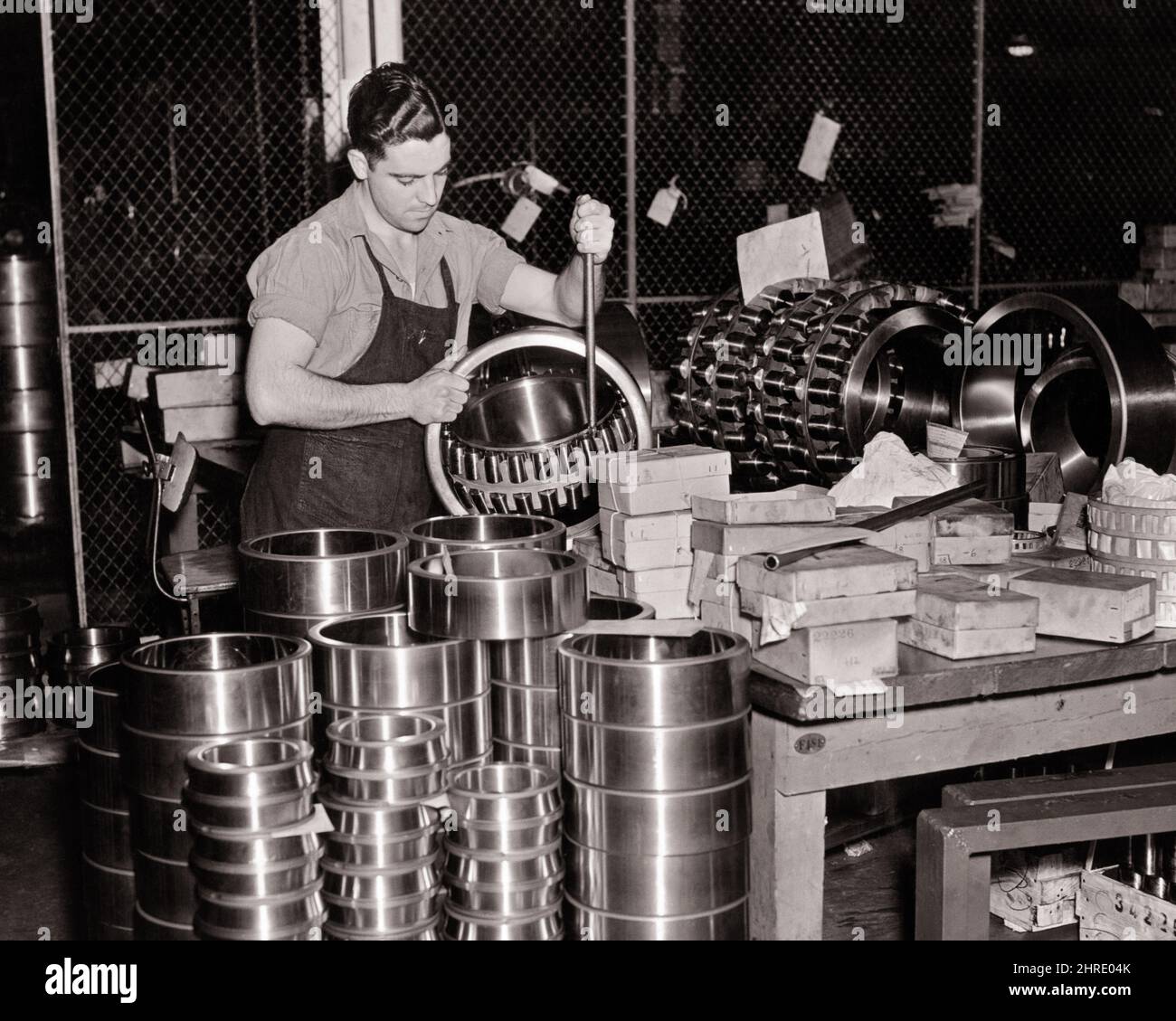 1940s MAN ASSEMBLING THE RETAINER OF A SPHERICAL ROLLER BEARING - i3617 ...