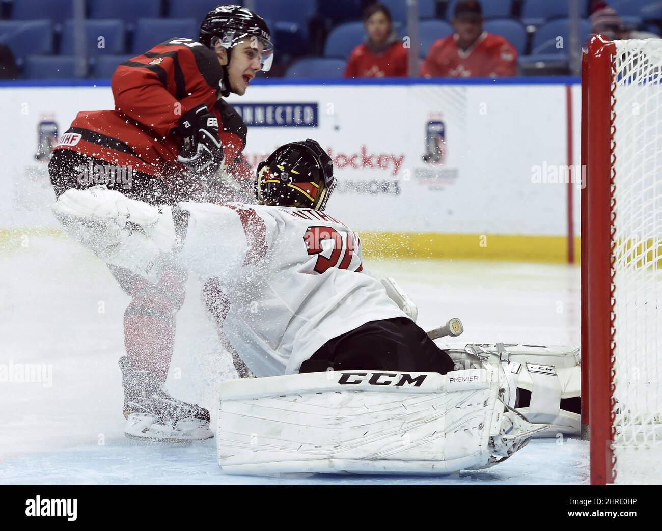 Canada's Michael McLeod (21) scores past Switzerland's Philip Wuthrich ...