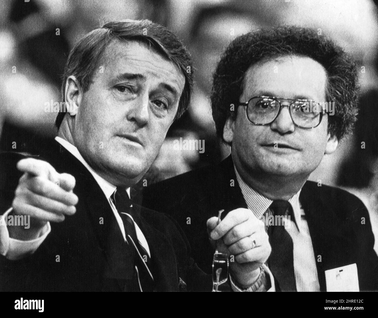 Prime Minister Brian Mulroney gestures as Stanley Hartt, Chair of the ...
