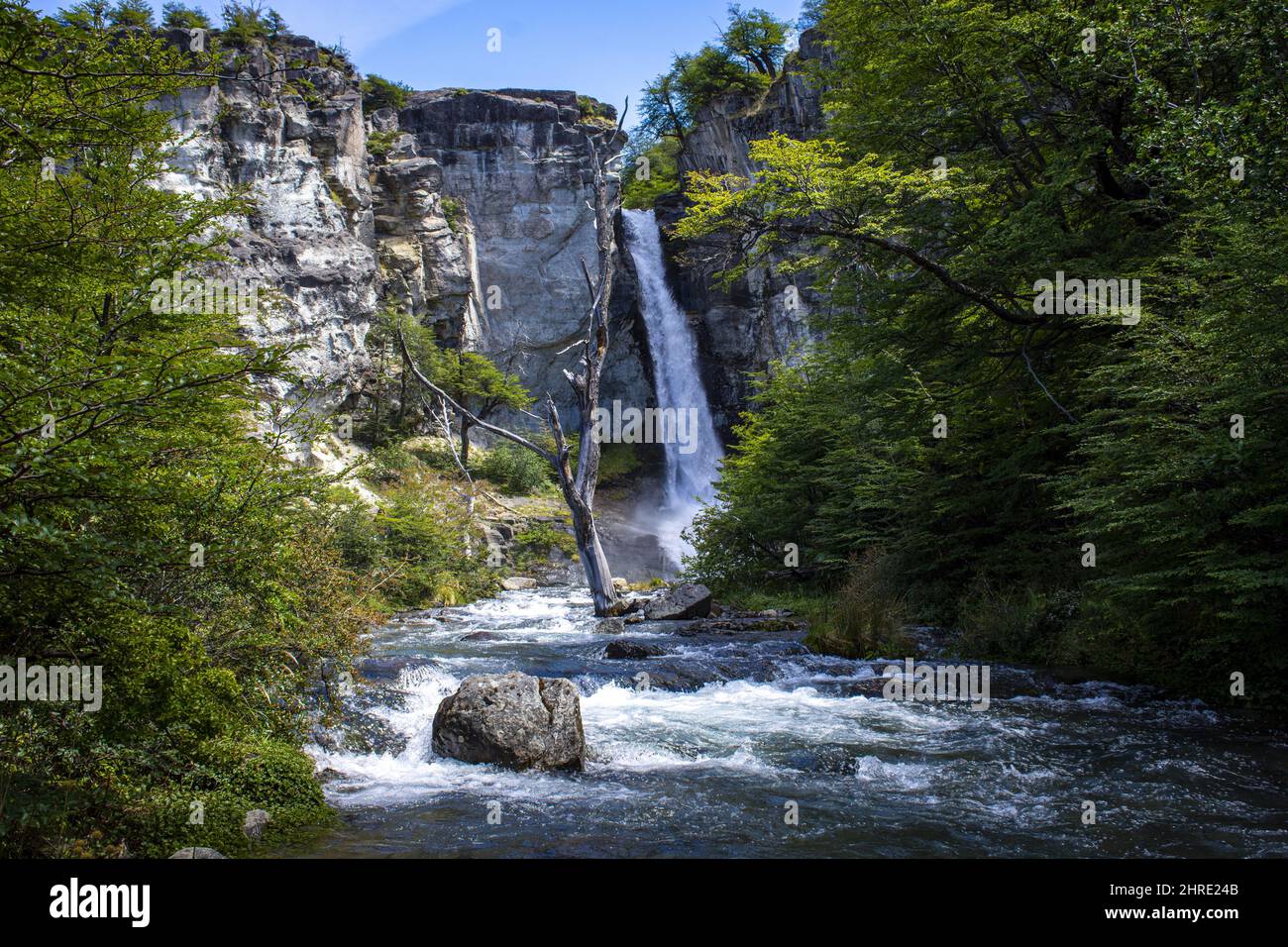 Beautiful view of a waterfall flowing through cliffs surrounded by ...