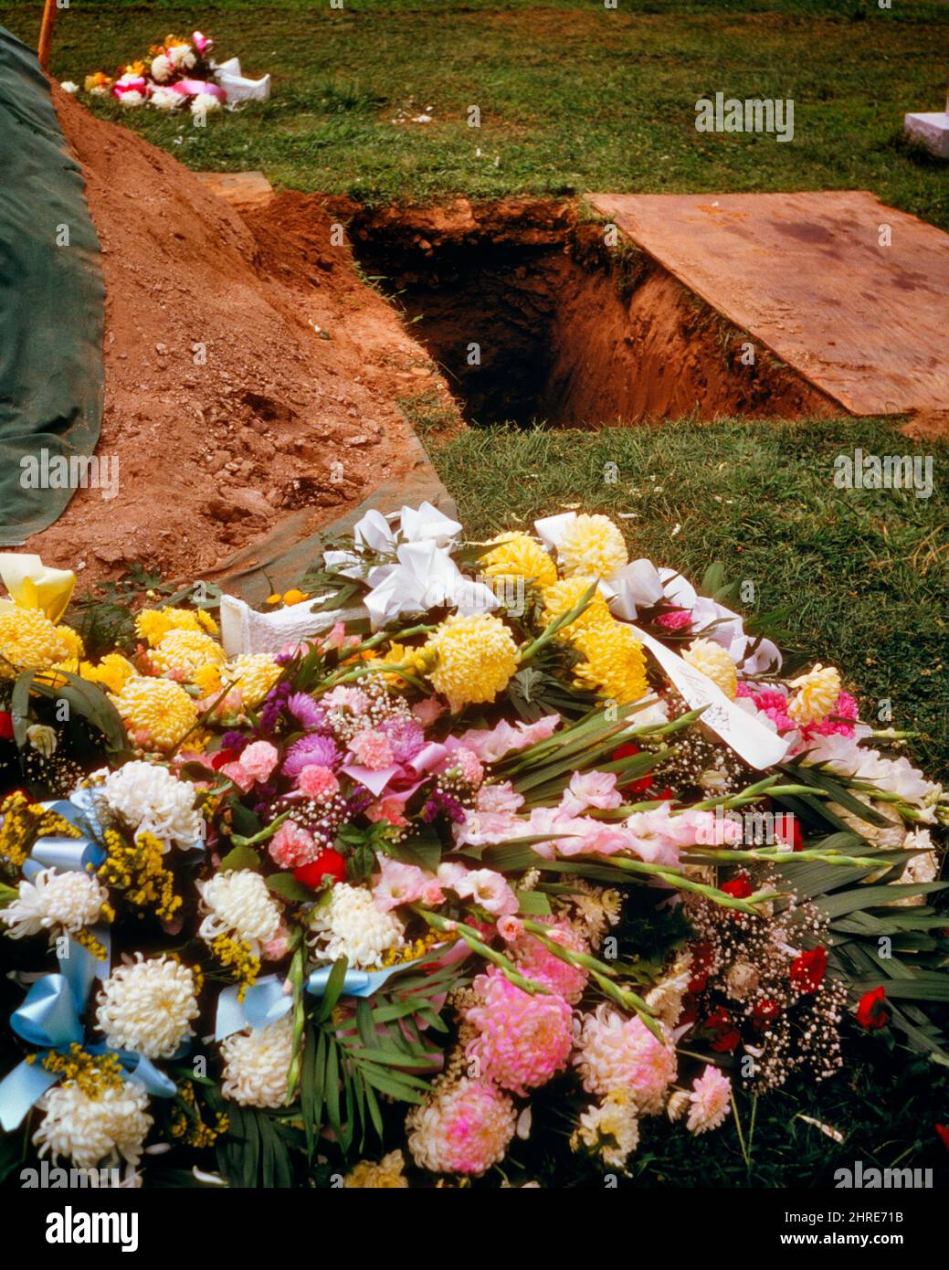 1970s FRESHLY DUG OPEN GRAVE WITH FUNERAL FLOWERS BY THE SIDE - kc7466 ...