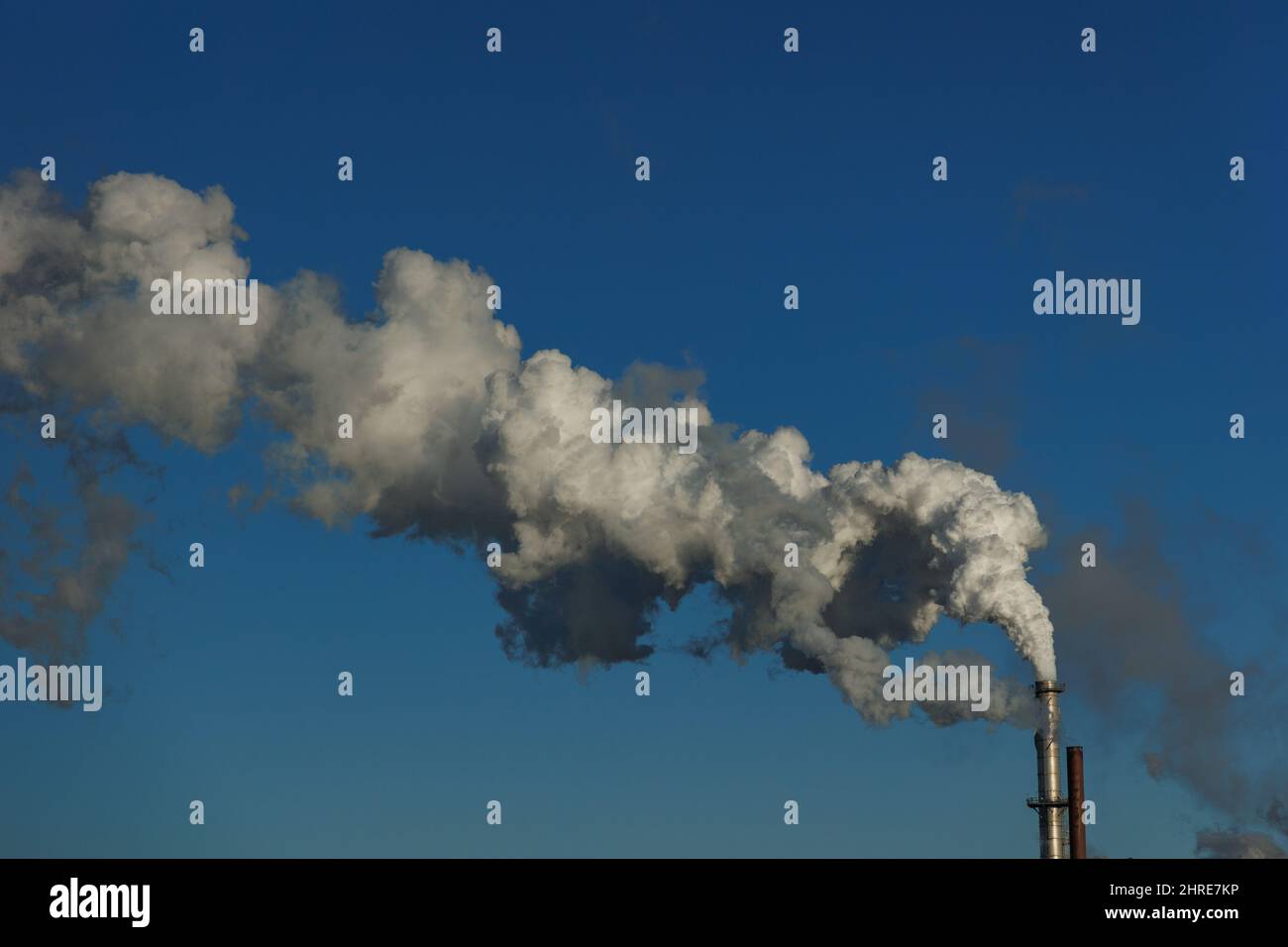 View of Steam coming out from a factory with blue sky Stock Photo - Alamy