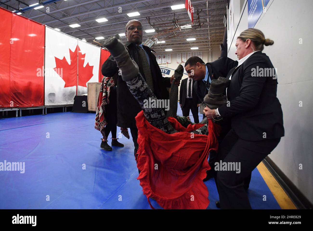 A protestor is carried out of the building by police officers during a ...