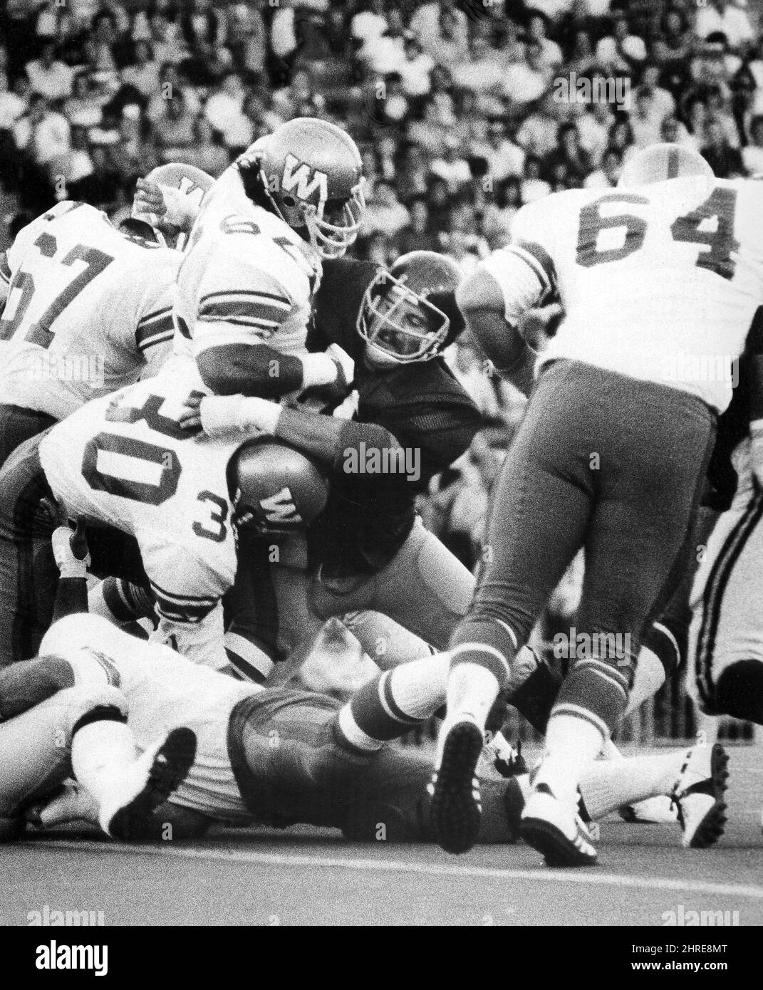Toronto Argonauts' Jim Stillwagon (centre) holds up a wall of Winnipeg ...