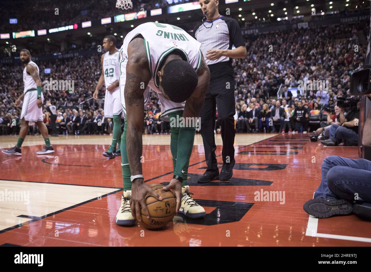 Boston Celtics guard Kyrie Irving picks up a loose ball that went out ...