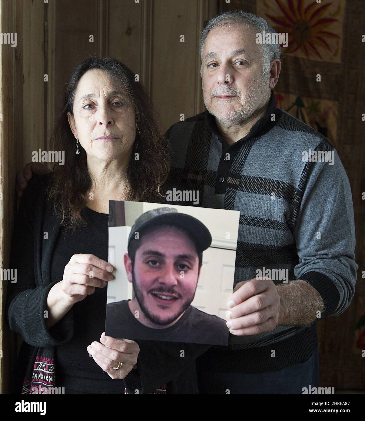 Jacob and Rachel Cohen hold up a photograph of their son Noam at their ...