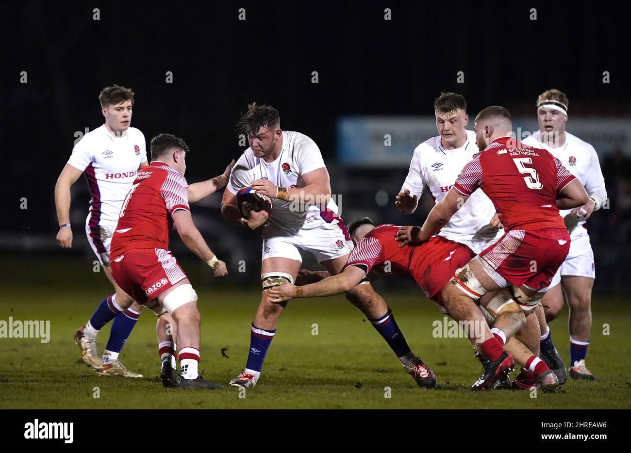 England's Charlie Rice is tackled by Wales' Ethan Fackrell (left) and ...