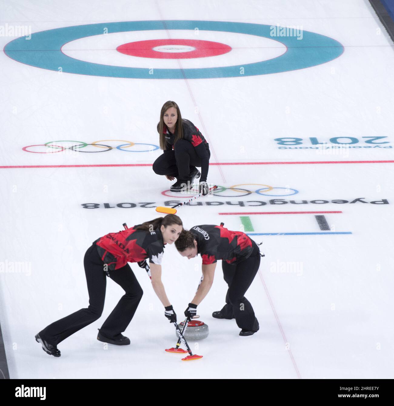 Canada's Lisa Weagle, left, and Joanne Courtney sweep a rock from skip ...