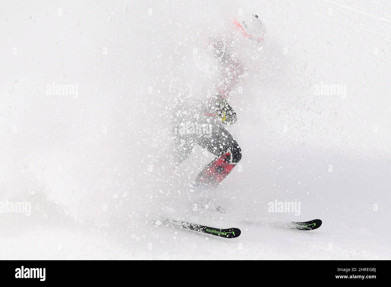 Brittany Phelan of Canada sprays snow as she crosses the finish line in ...